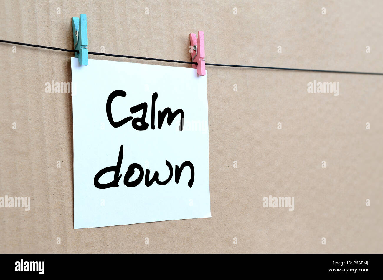 Calm down. Note is written on a white sticker that hangs with a ...