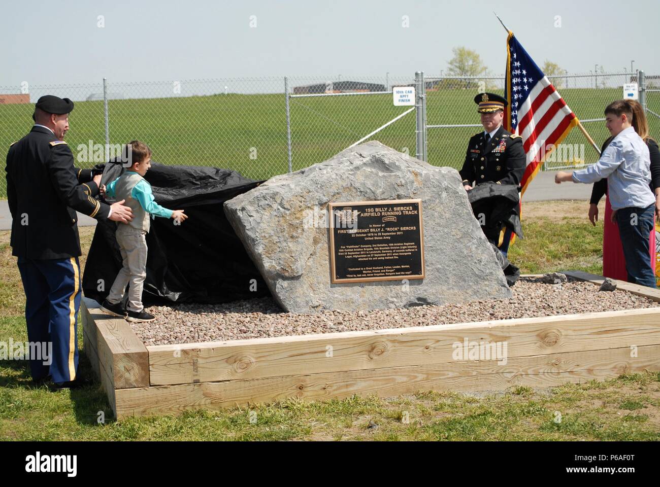 Family members of 1st Sgt. Billy J. Siercks unveil the plaque designed ...