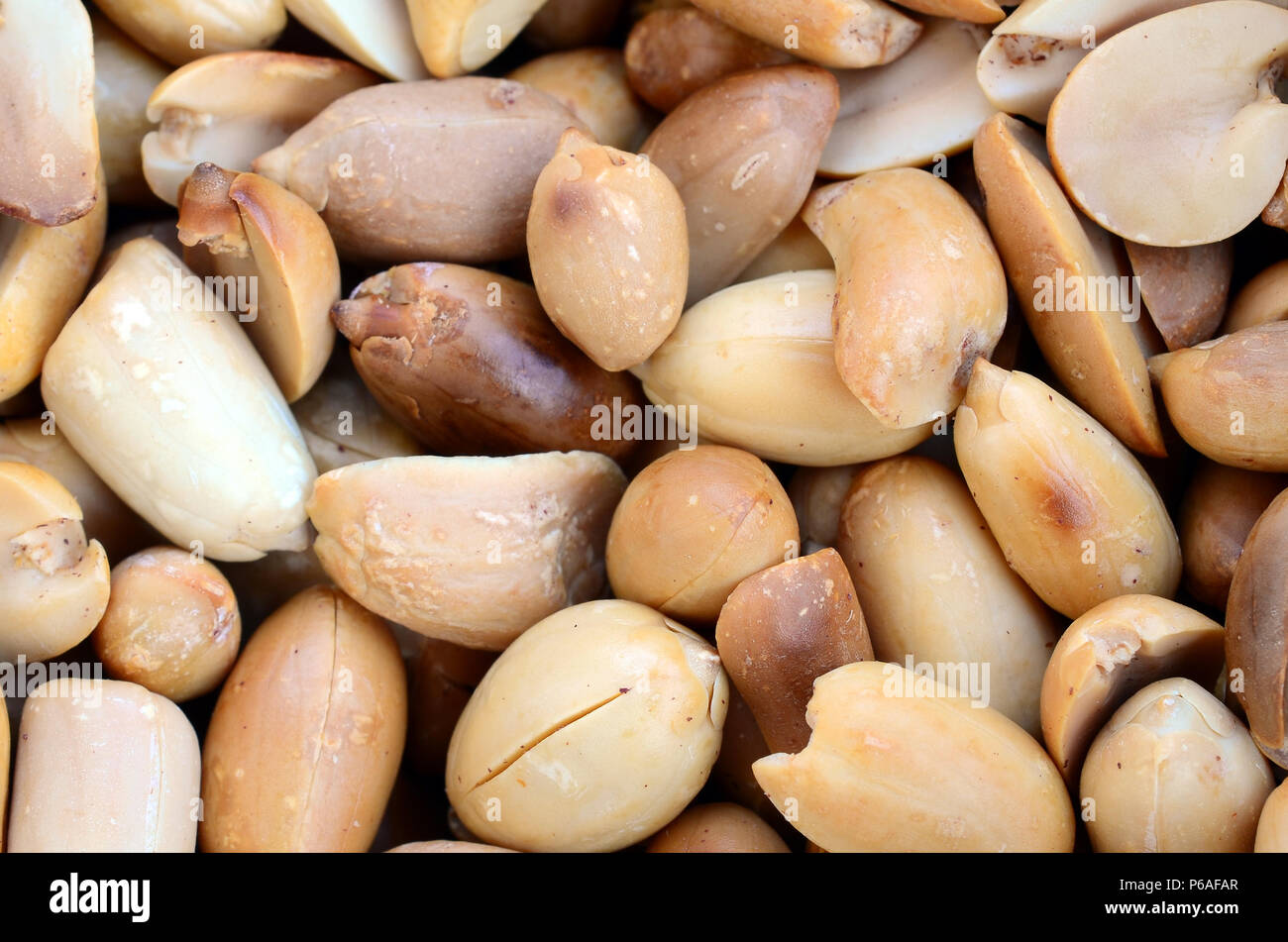Peanut. A lot of small yellow nuts without peel. Background texture ...