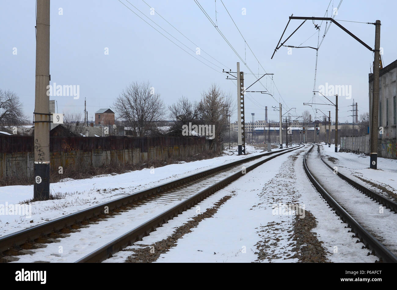 Winter railway landscape. Industrial zone. The railroad between the ...
