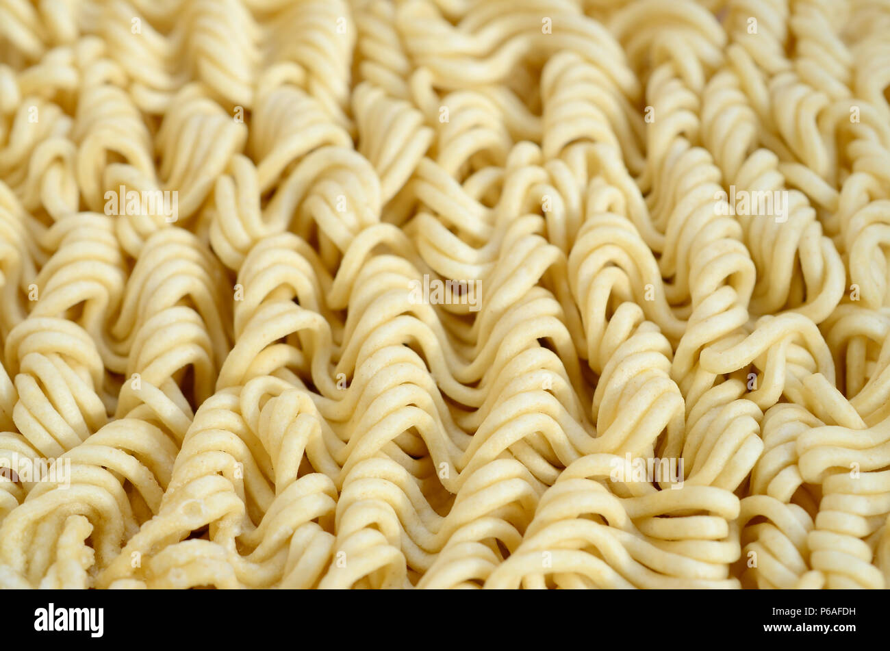 Close up view of yellow dry instant noodles. Chinese traditional food ...