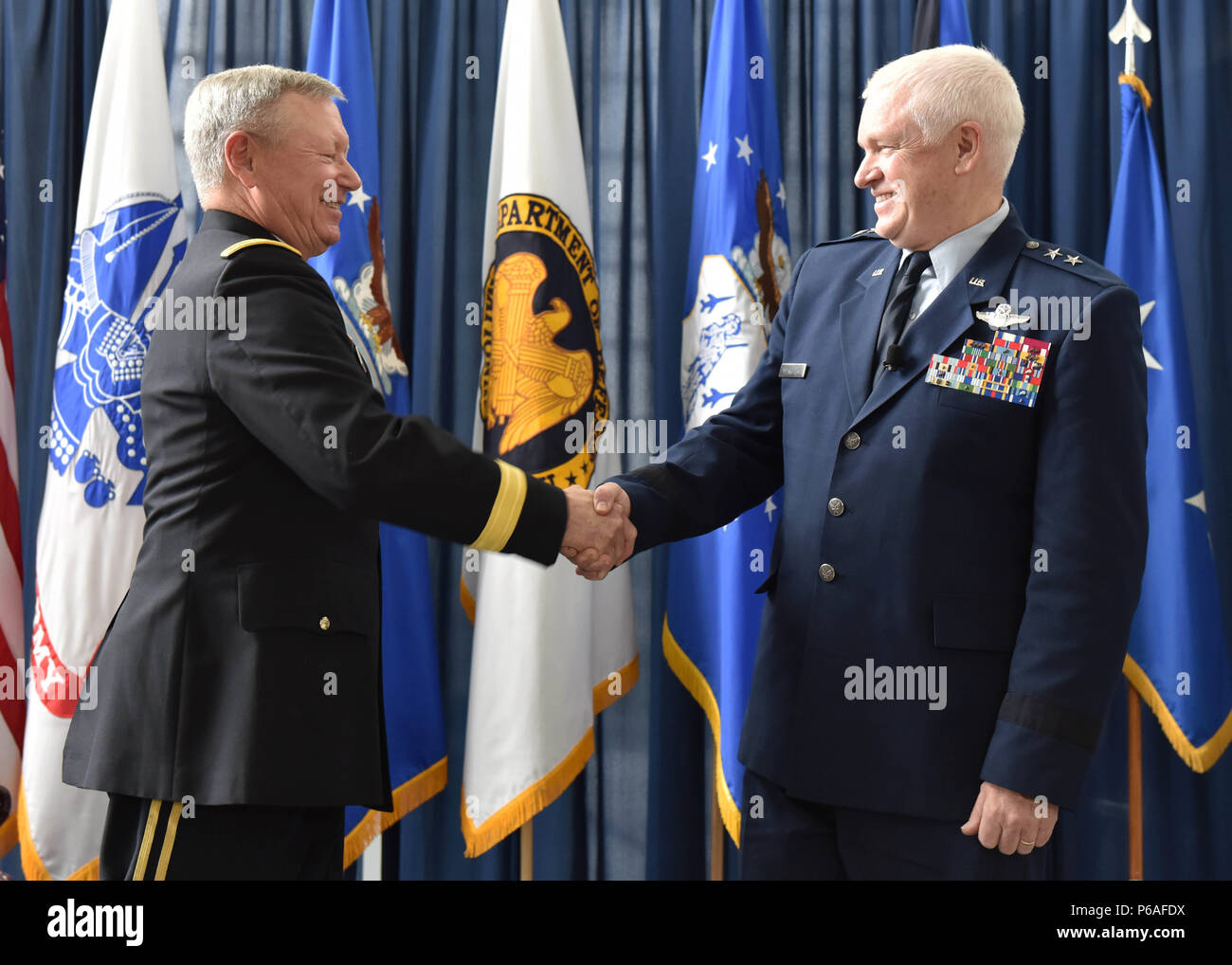 Army Gen. Frank Grass, chief of the National Guard Bureau, shakes hands ...