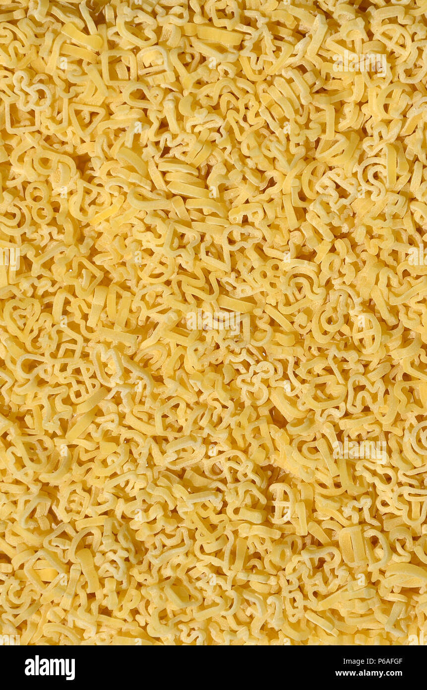 Texture of a lot of curly raw yellow pasta Stock Photo - Alamy