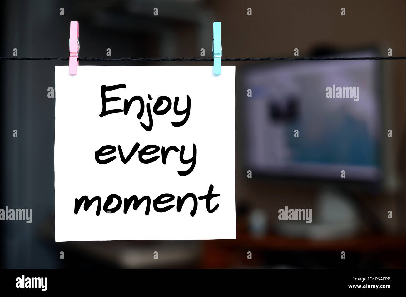 Enjoy every moment. Note is written on a white sticker that hangs with ...