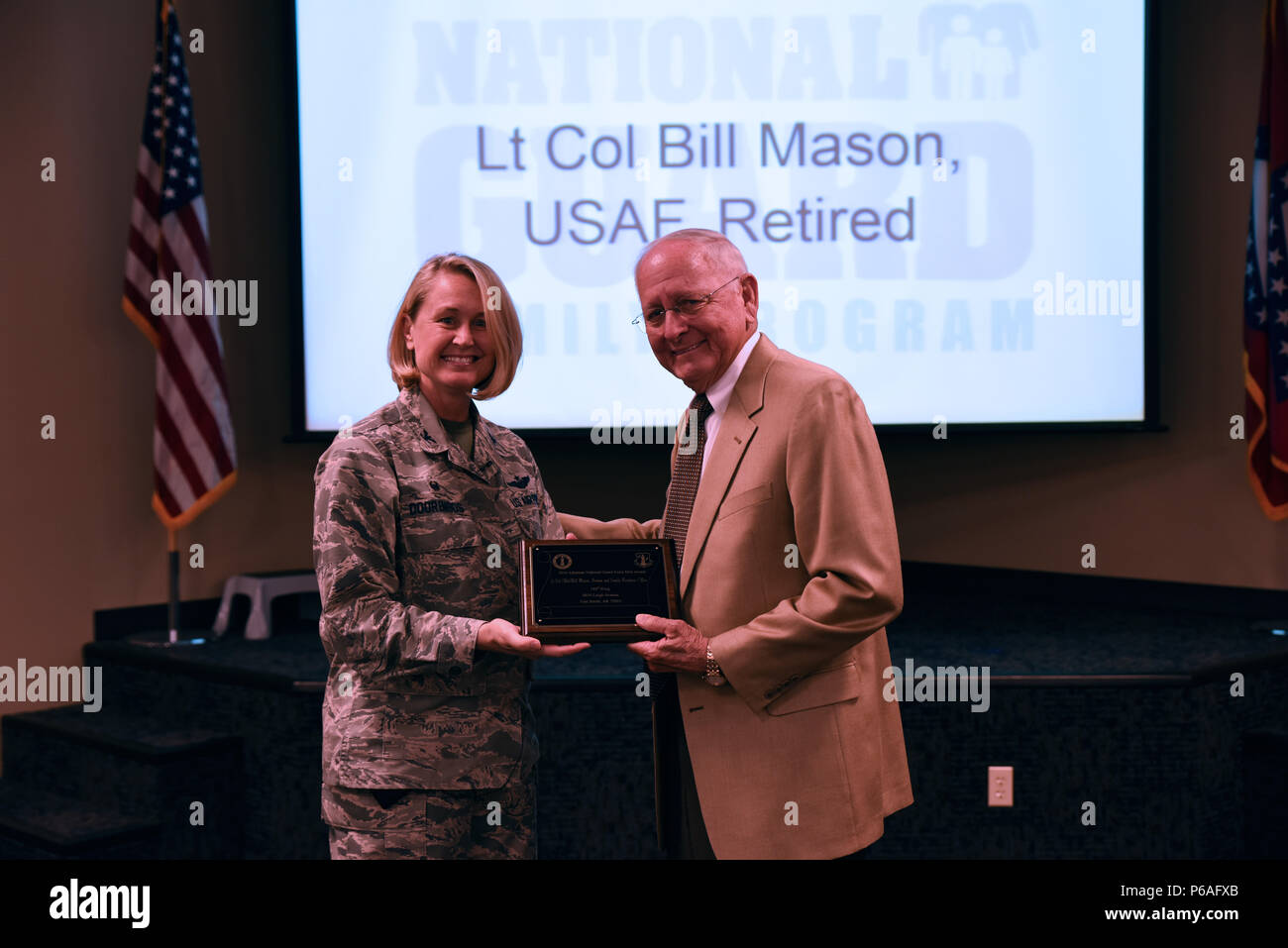 Ret. Lt. Col. Bill Mason receives the Extra Mile Award from Col. Bobbi ...