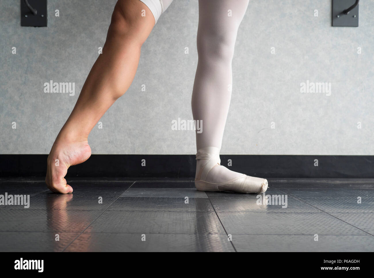 The hardworking disciplined ballerina ballet dancer warming up in her ...