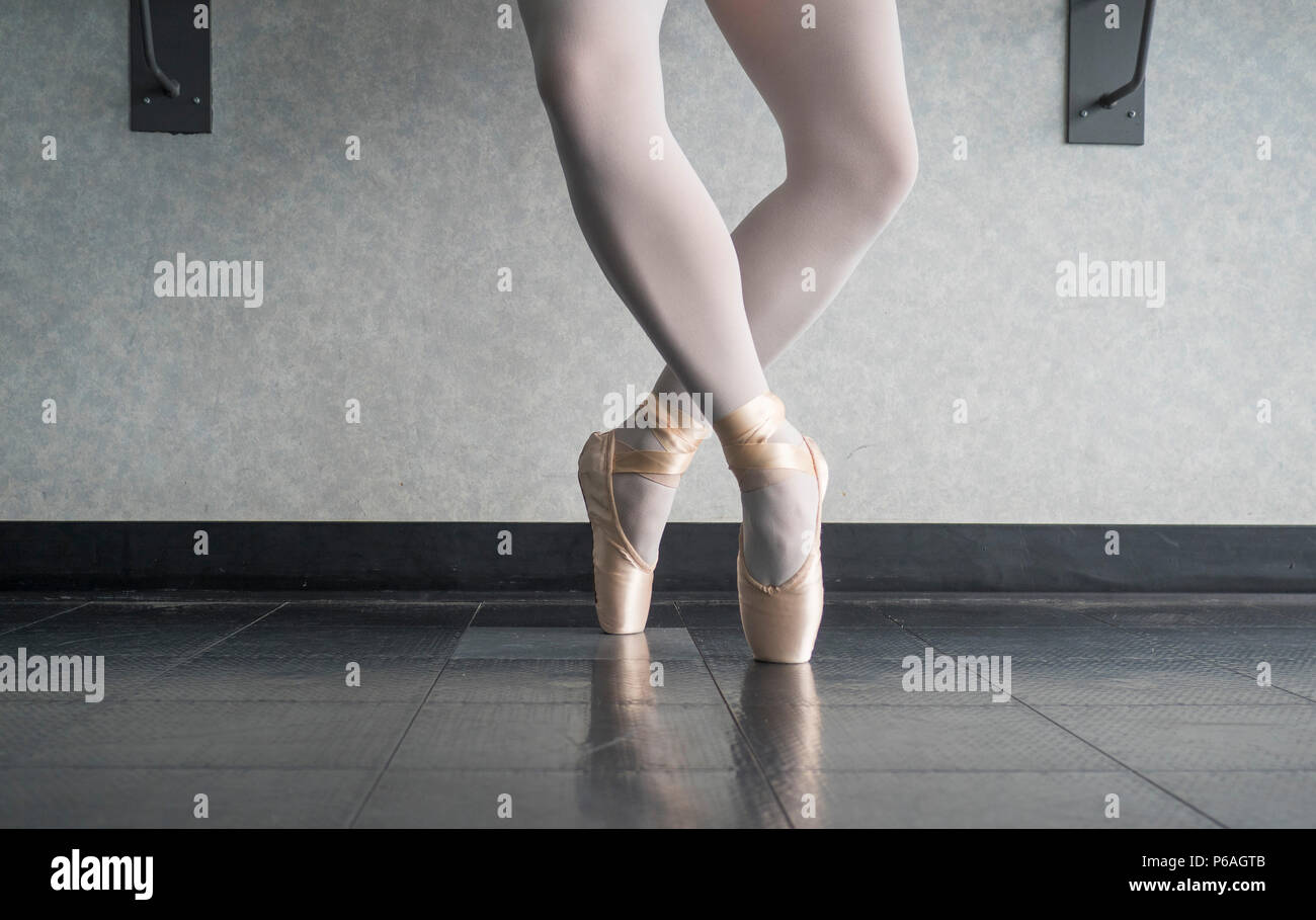 Ballerina dancer in the ballet studio en pointe in releve fourth ...