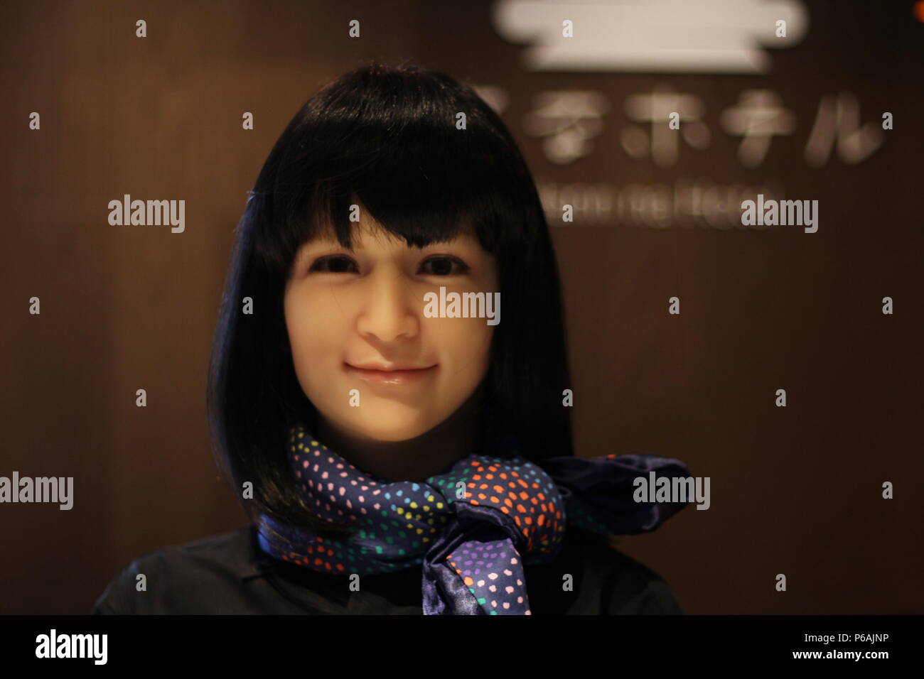 A robot receptionist working on the reception desk of a Henn na Hotel ...