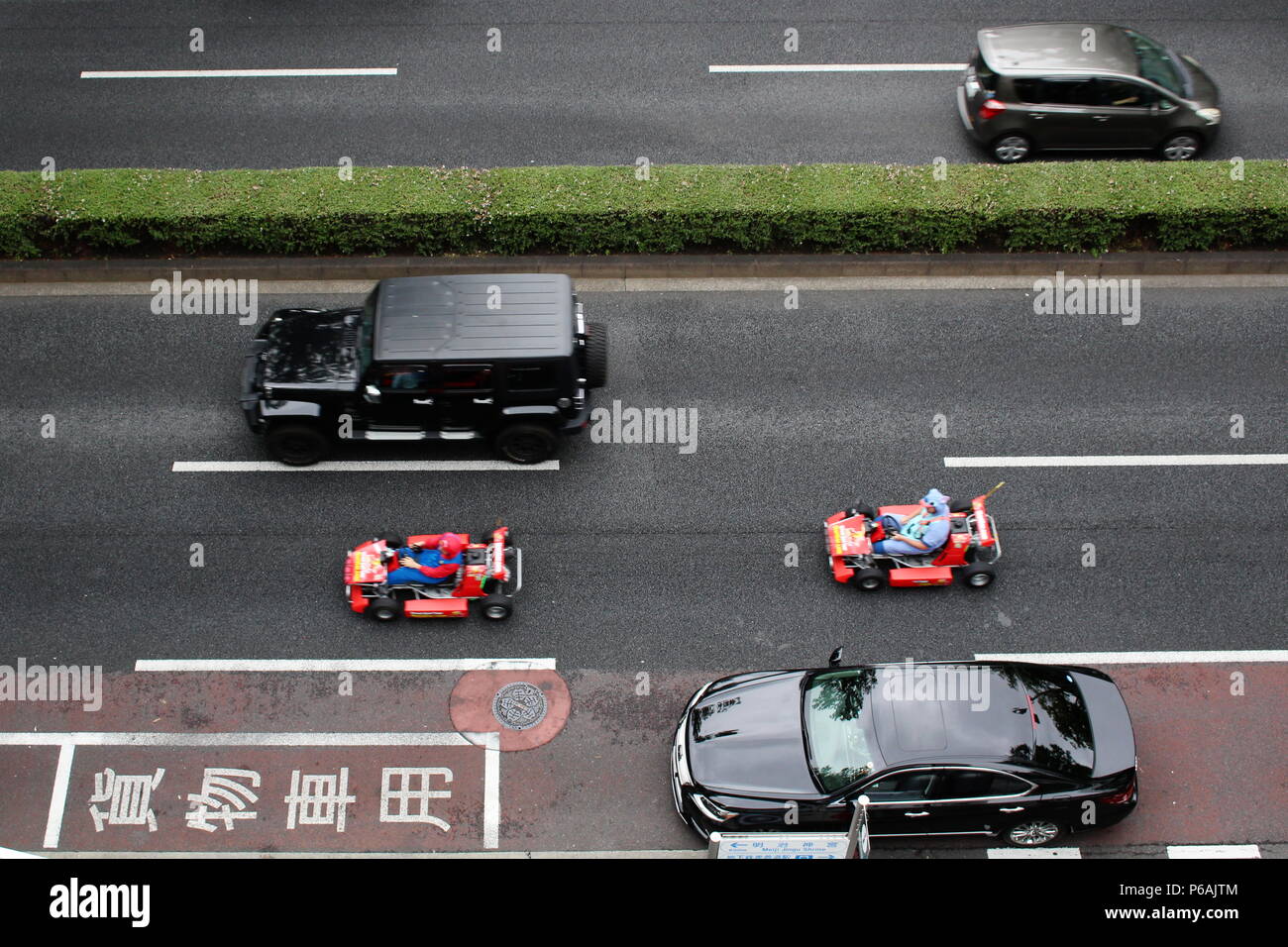 Overhead view of road in Omotesando with a pair of rental Maricar go ...