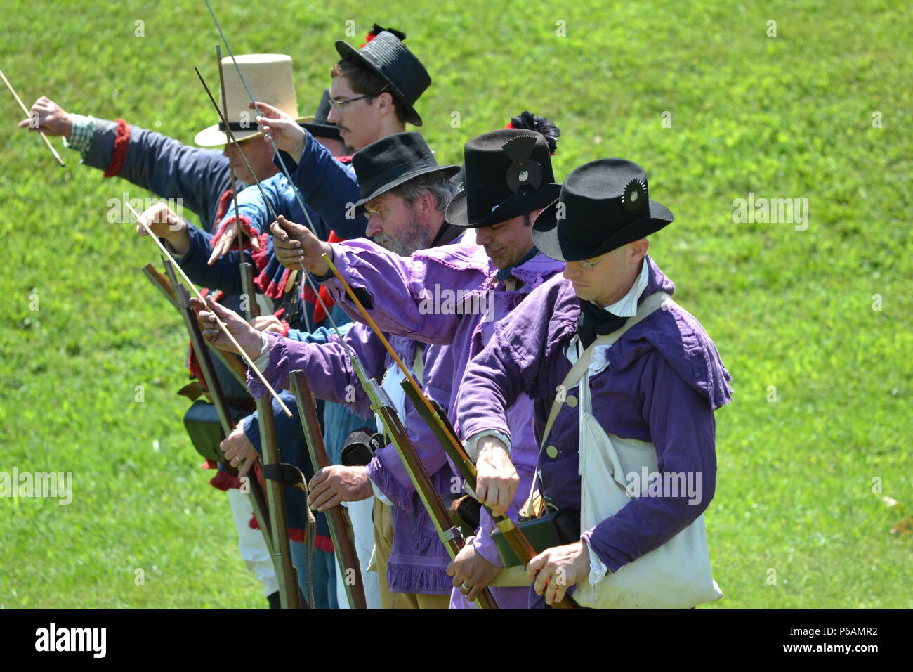 Re-enactors reloading period specific muskets during a field maneuver ...