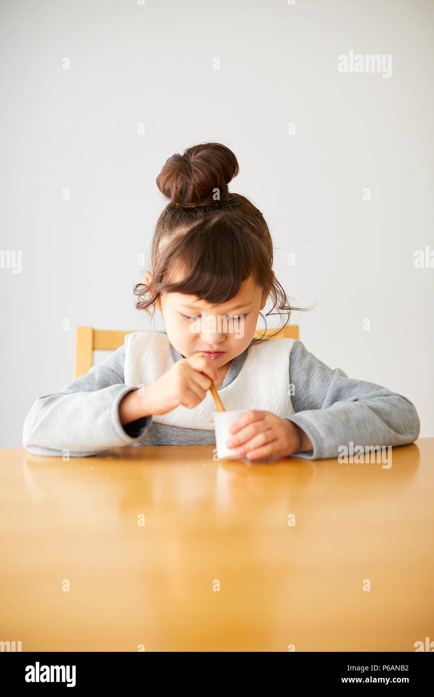 Cute Japanese kid having a snack Stock Photo - Alamy