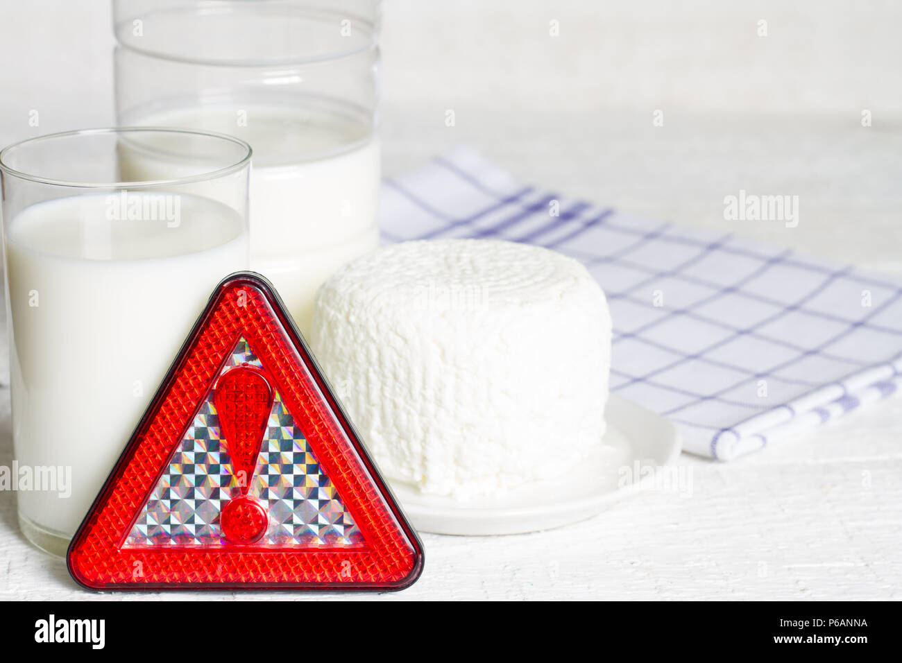 Lactose intolerance with milk dairy product and warning sign concept ...