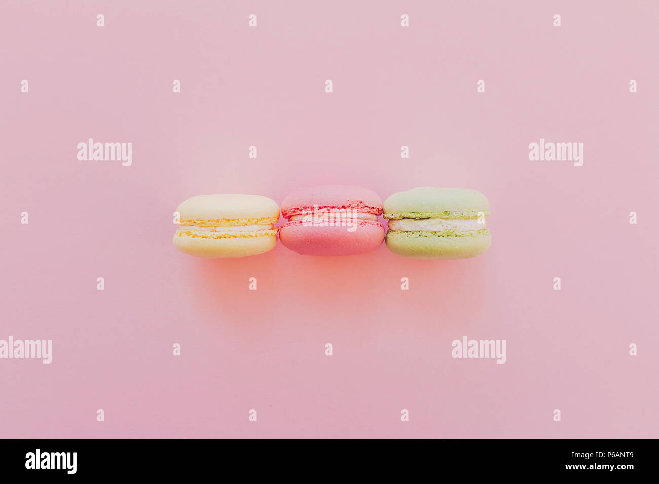stylish colorful macaroons on trendy pink paper, flat lay. space for ...