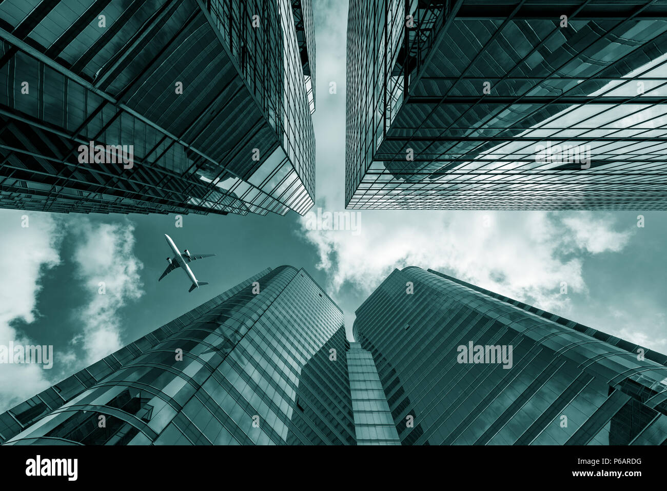 Exterior of the office buildings and plane in the sky Stock Photo - Alamy
