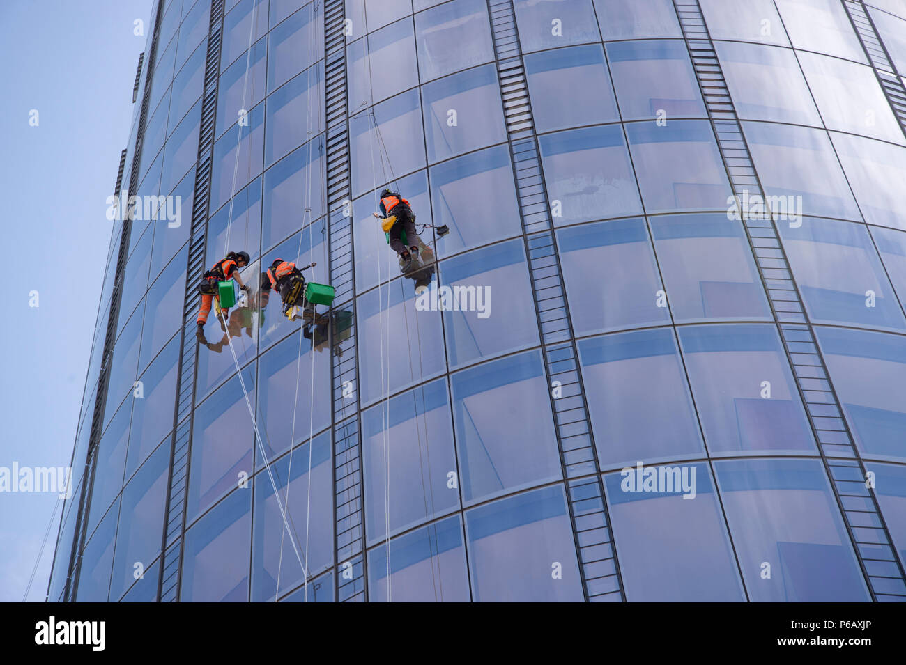 London. Blackfriars. Window cleaners abseil down the side of a new ...