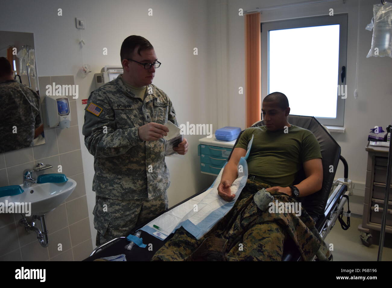 Specialist Bowman (center), a medic with the 230th Engineer Battalion ...