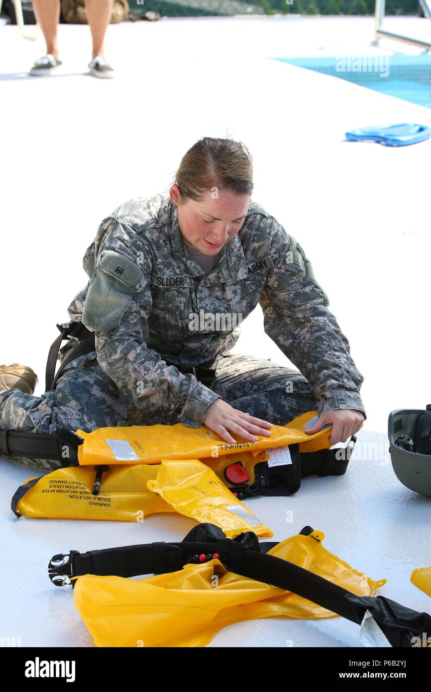 A Trooper assigned to Joint Task Force Guantanamo reassembles her gear ...