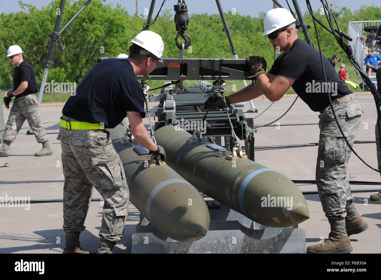 U.S. Air Force Airmen assigned to the 7th Munitions Squadron prepare an ...