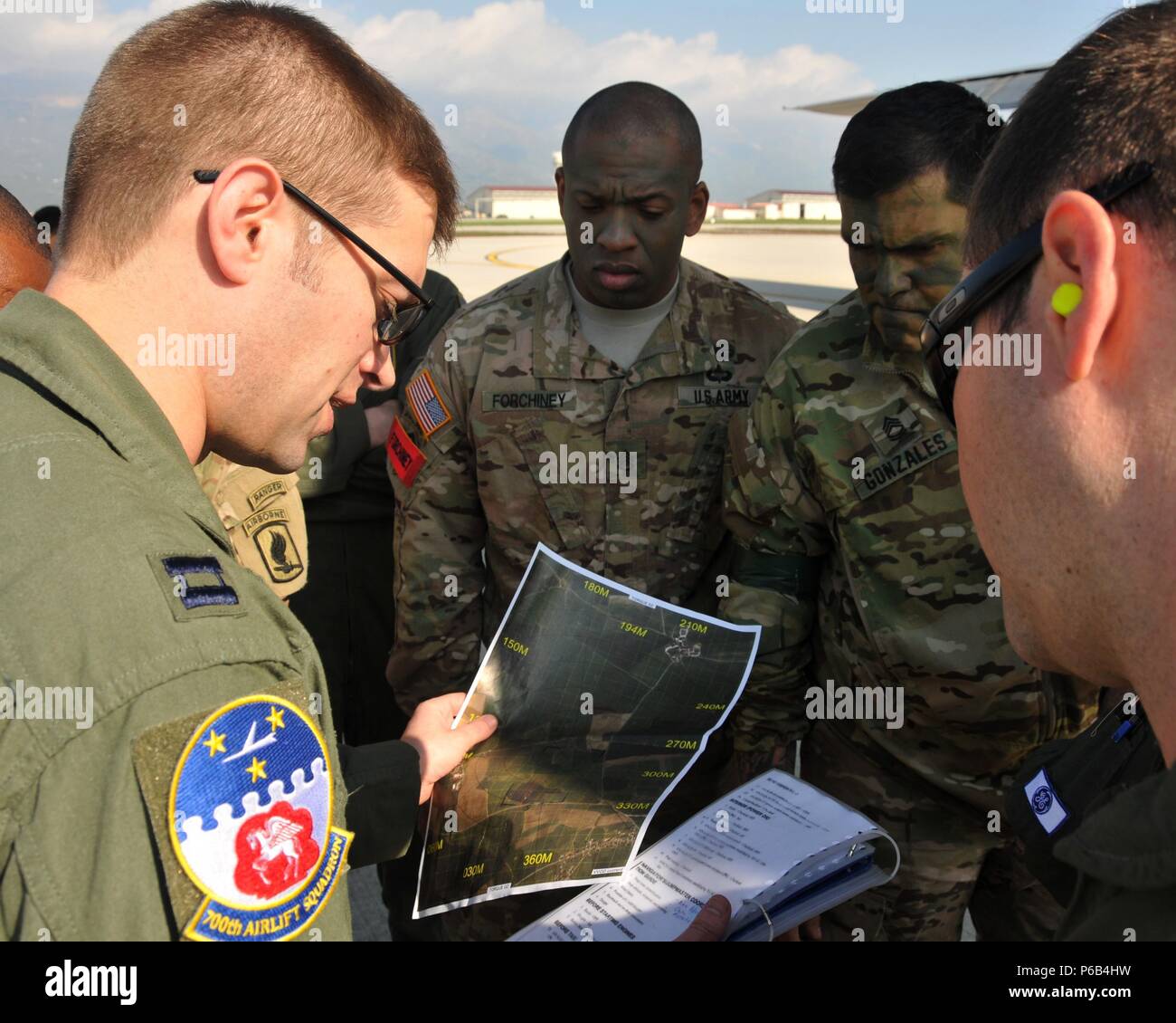 Capt. Christopher Retzlaff, 700th Airlift Squadron navigator, briefs ...