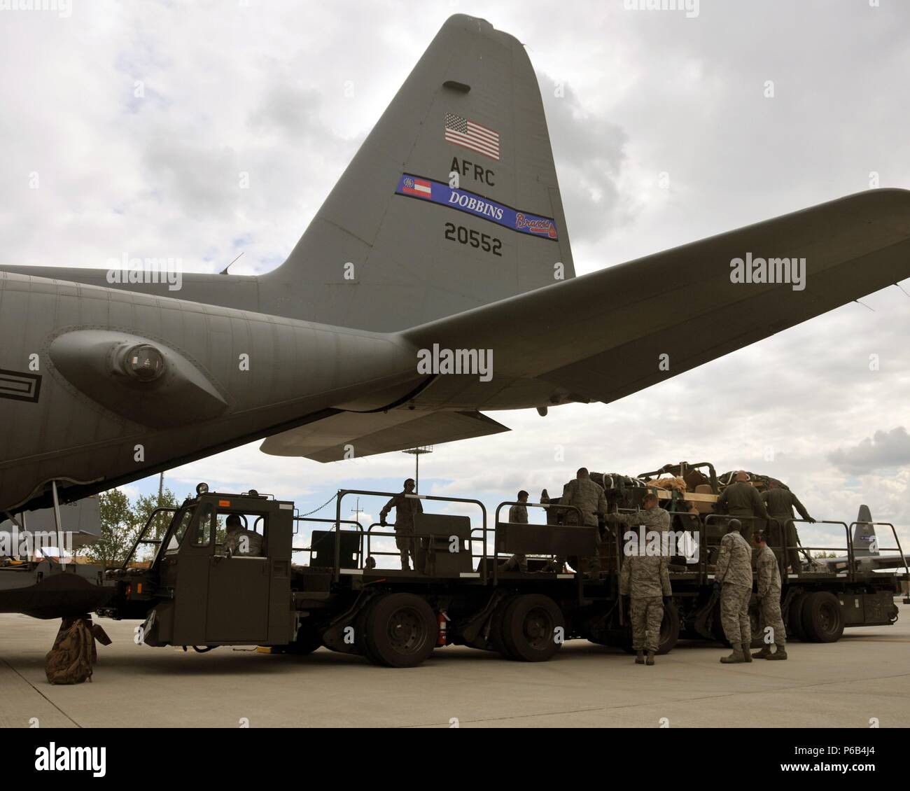 A load team uses a K-Loader to load a Humvee into the cargo area of a C ...