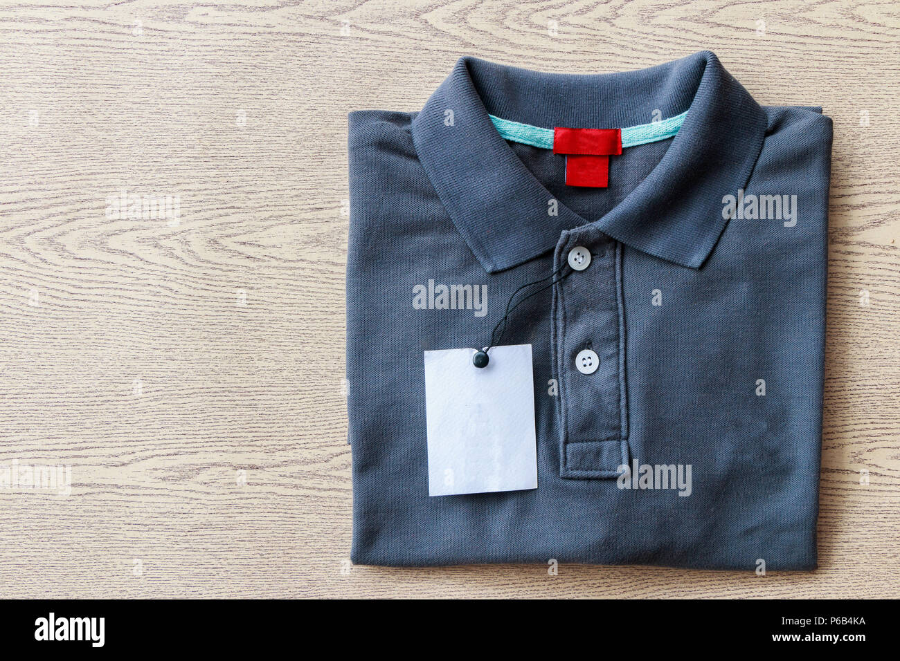 Close up top view of man polo shirt put on rustic wooden table top with ...