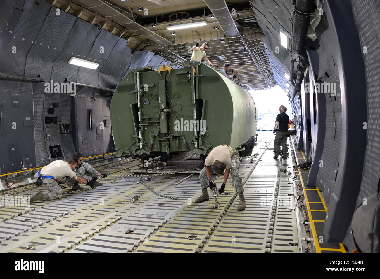 Airmen from the 60th Aerial Port Squadron load a C-5M Super Galaxy with ...
