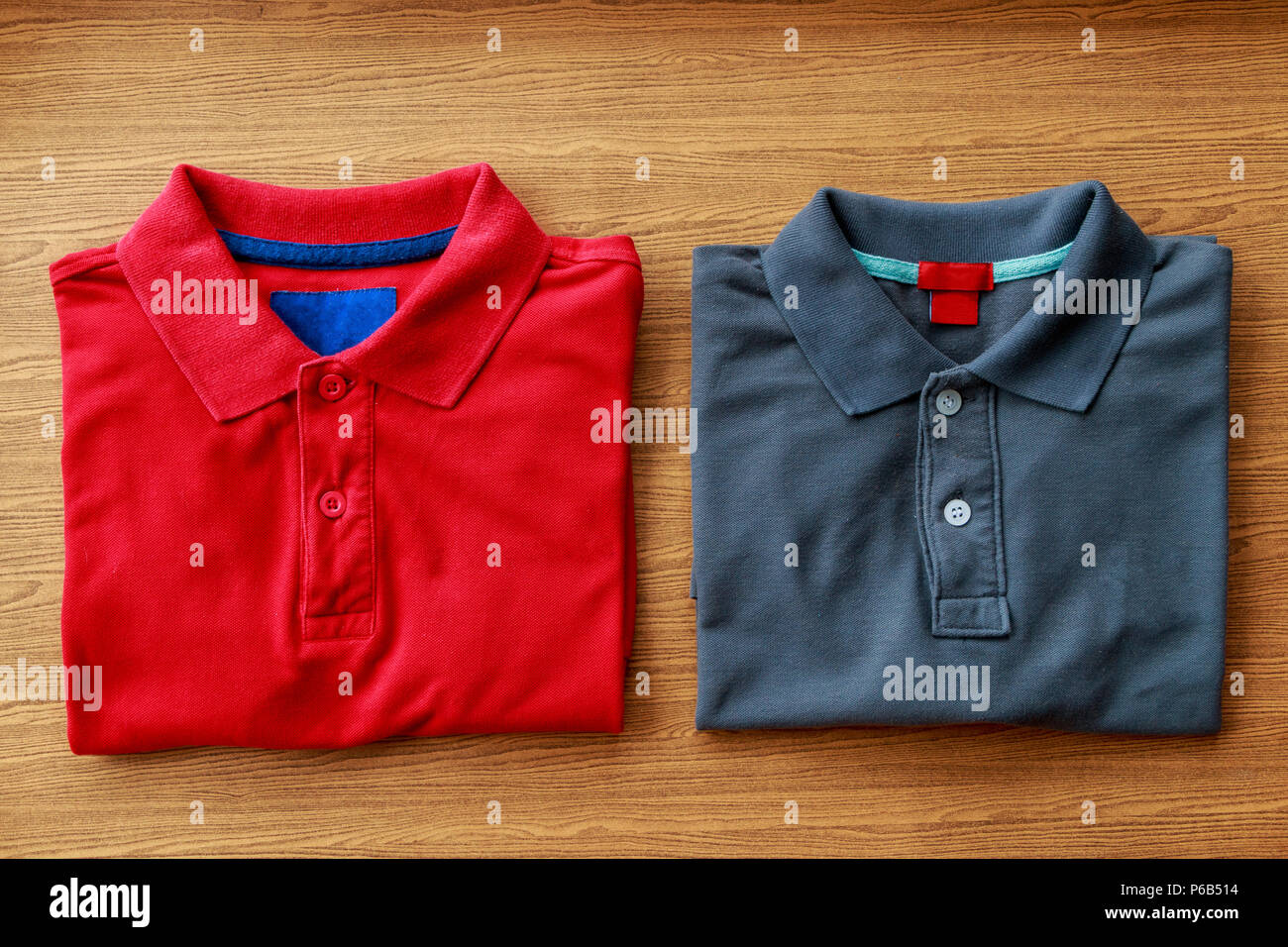 Close up top view of man polo shirt put on rustic wooden table top with ...