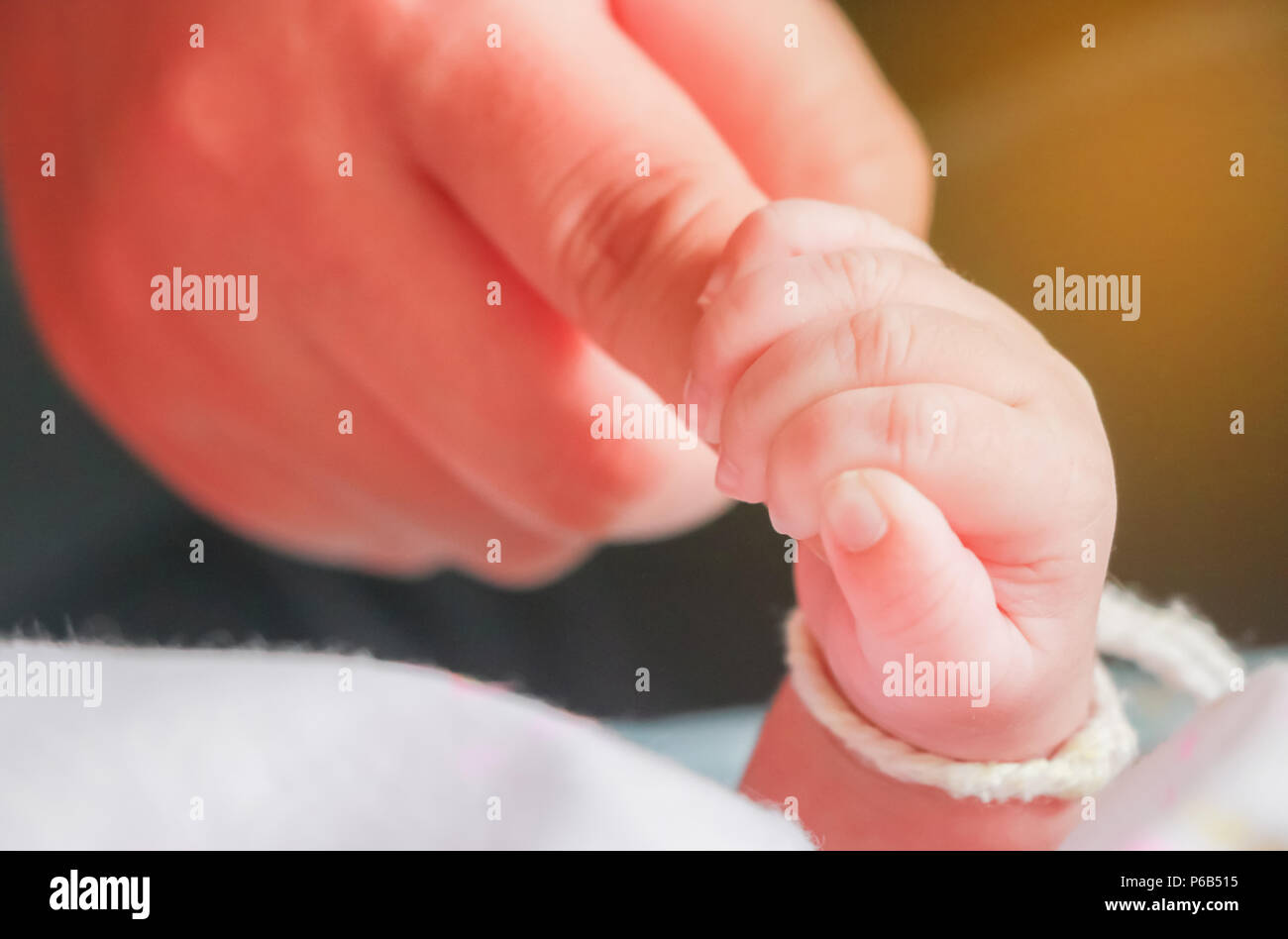 baby hand in mom's hand whilst asleep Stock Photo - Alamy