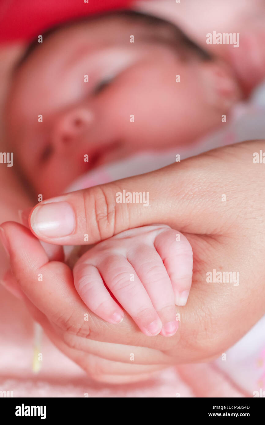 baby hand in mom's hand whilst asleep Stock Photo - Alamy