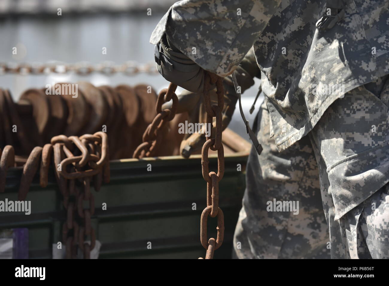 A 226th Composite Supply Company mechanic, grabs a chain on the M/V ...