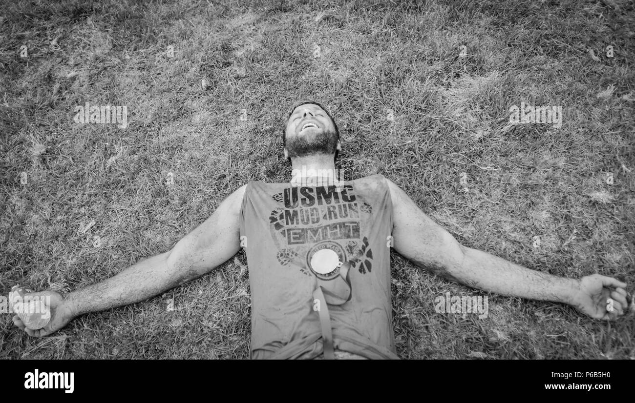 A participant relaxes at the finish line after the USMC Ultimate ...