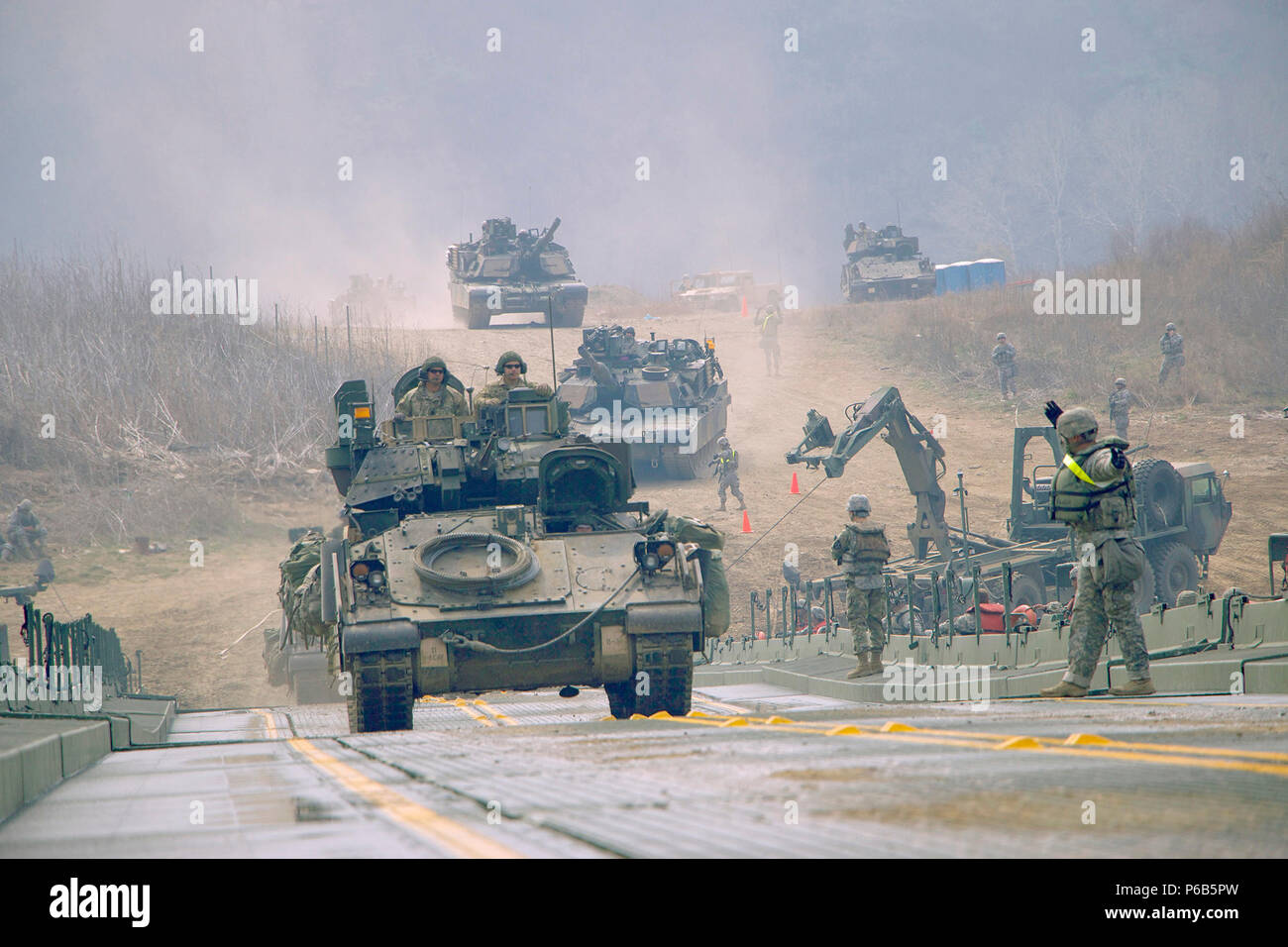 Crossing over a floating bridge April 6, Soldiers drive 68-ton M1A2 ...