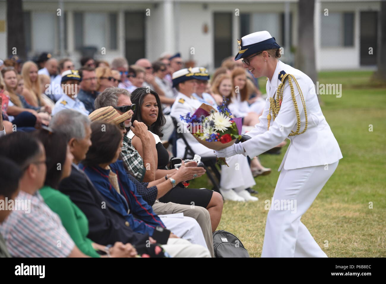 Lt. Julia T. Kane gives flowers to the parents of Capt. Charlene Downey ...