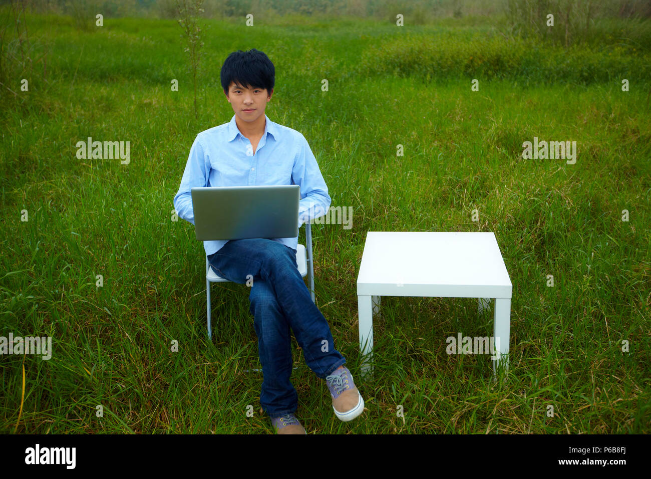 Young asian man using computer in home office Stock Photo - Alamy