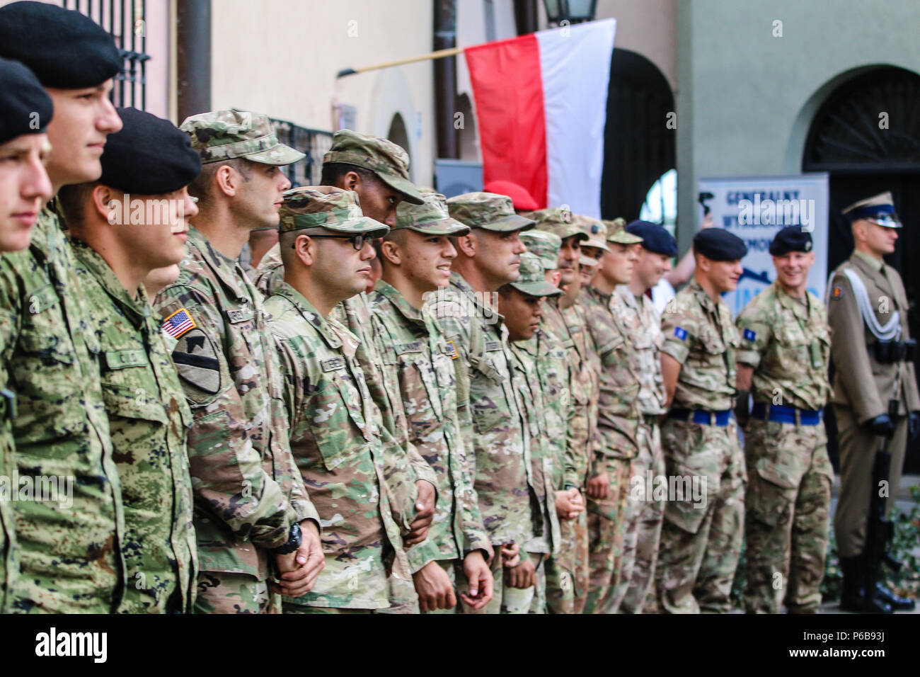 A multinational formation of soldiers from Battle Group Poland waits to ...