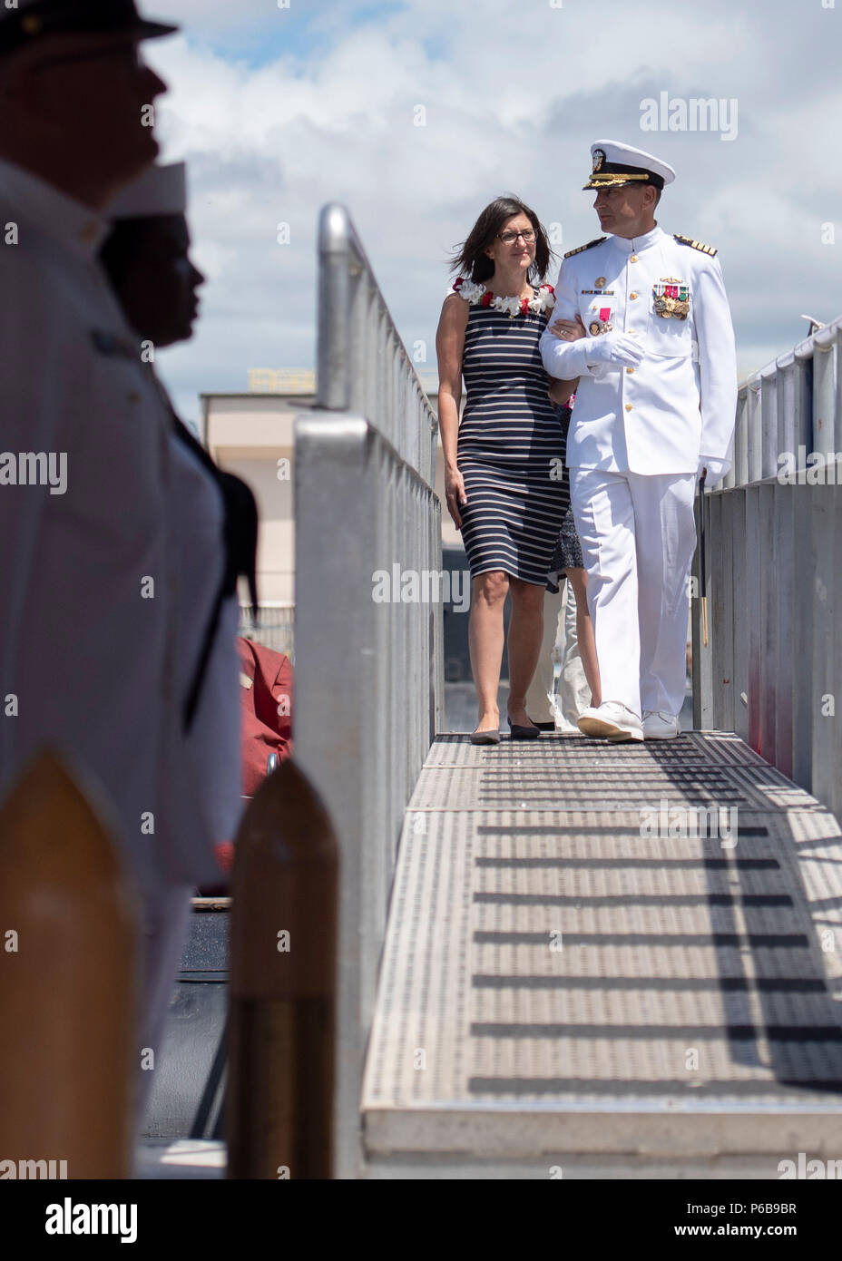 Capt. Robert A. Roncska (Ret.) and his family are piped ashore during ...