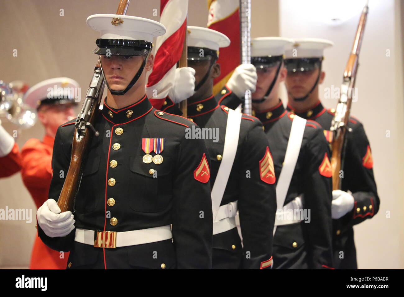The U.S. Marine Corps Color Guard march the National Ensign and the U.S ...