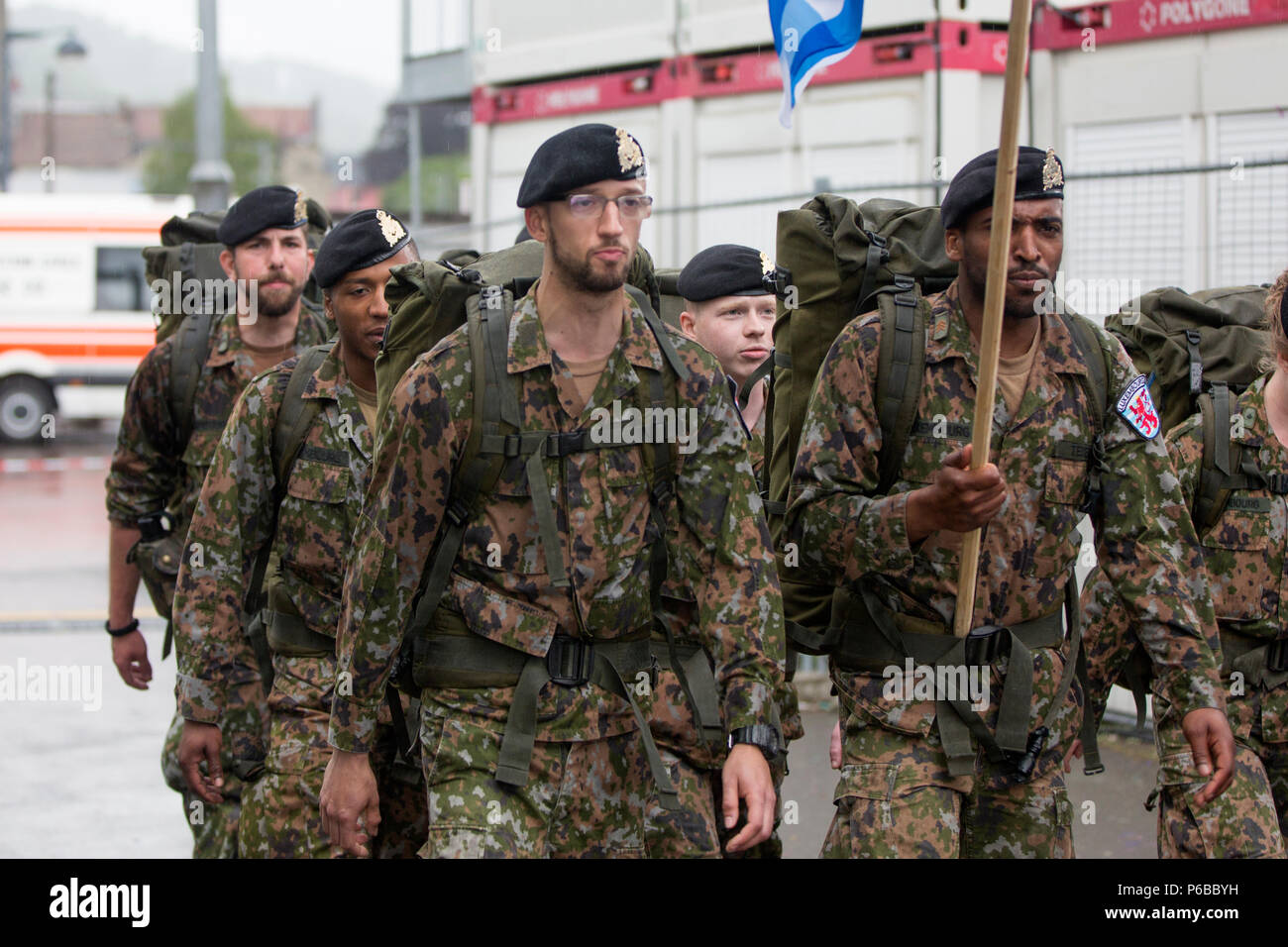 A team of Luxembourg Soldiers cross the finish line during the 49th ...