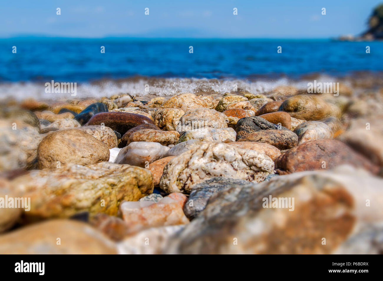Sea shore stone wave background Stock Photo - Alamy