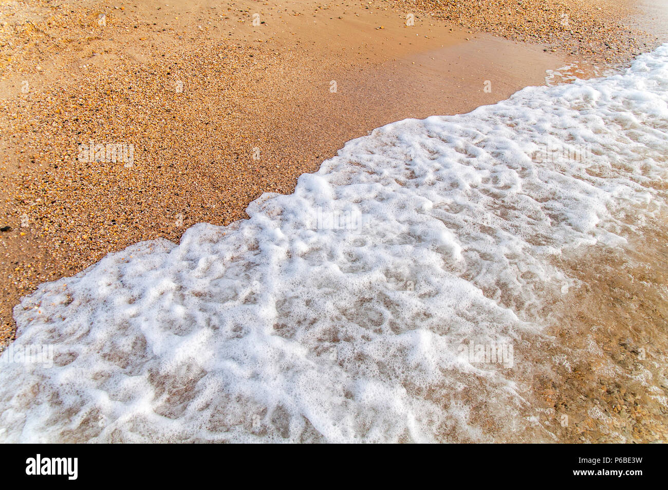 Small foam wave on sea close with beach Stock Photo - Alamy