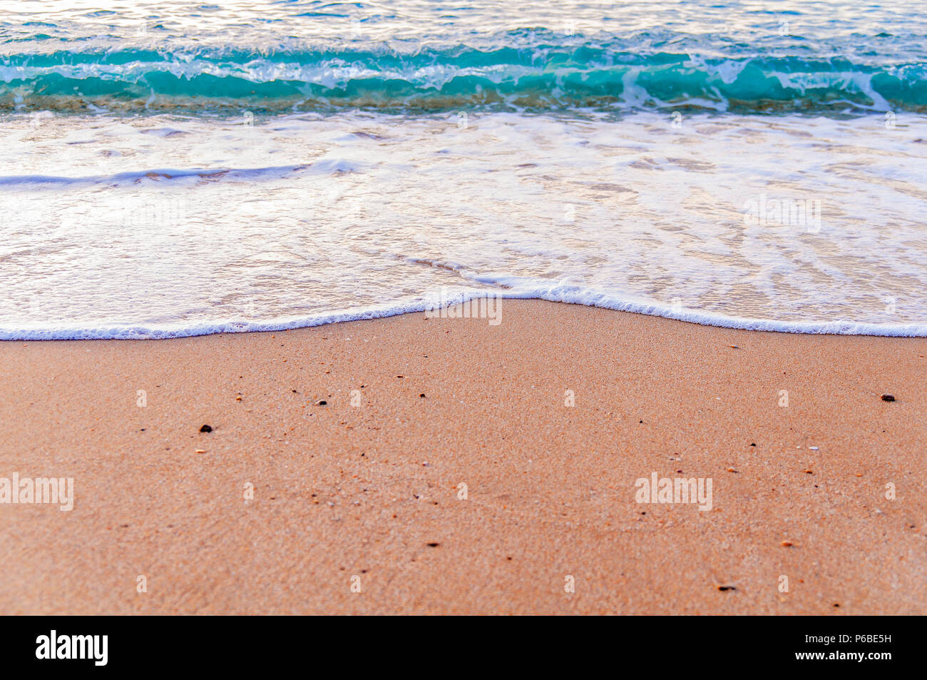 Small foam wave on sea close with beach Stock Photo - Alamy