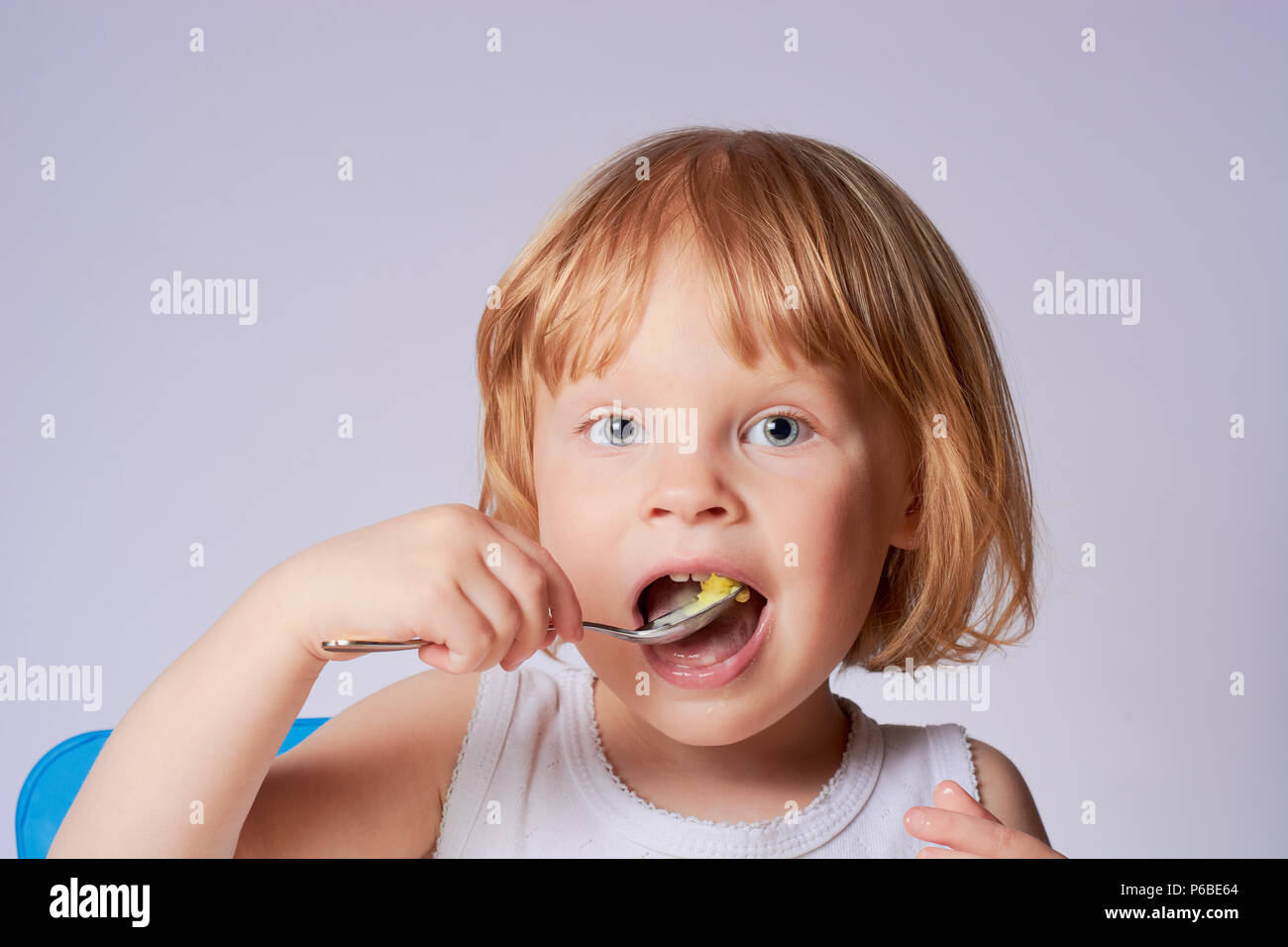 baby eating ice cream at the table spoon by herself Stock Photo - Alamy