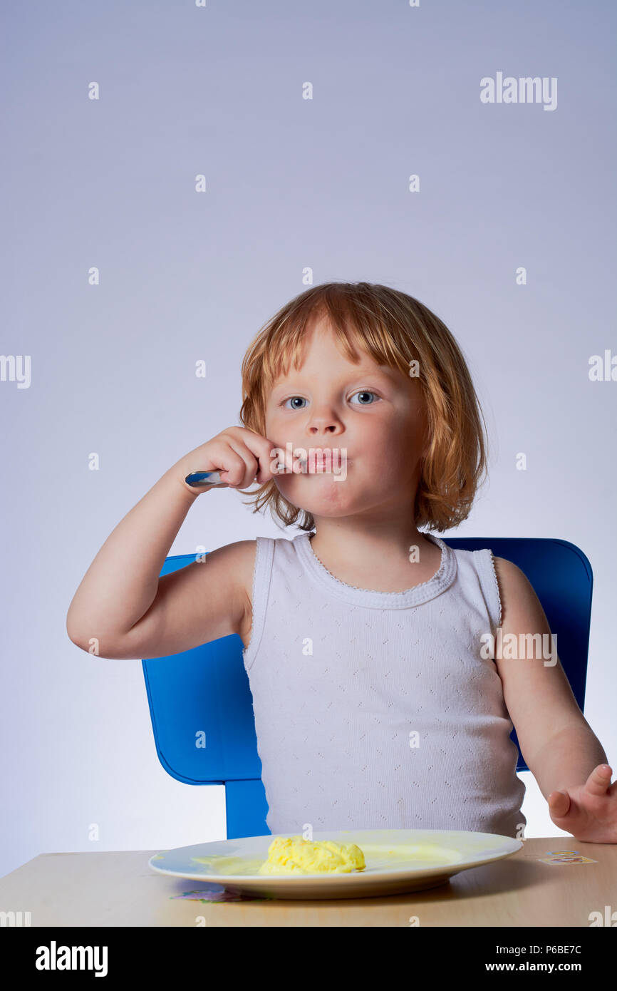 baby eating ice cream at the table spoon by herself Stock Photo - Alamy