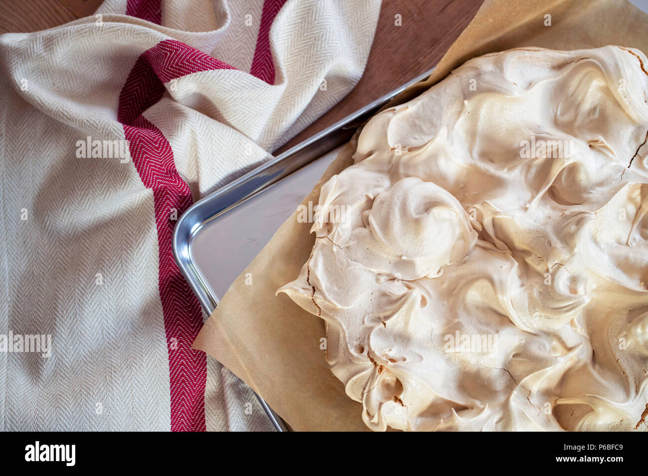 Cooking the meringue base for a Pavlova dessert. Fresh meringue, with ...