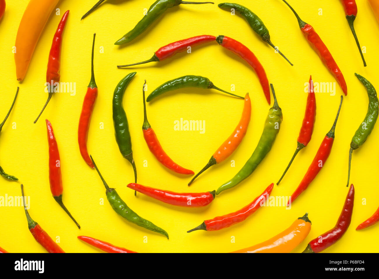 Assorted chili pepper tomato cherry On yellow bright background Stock ...