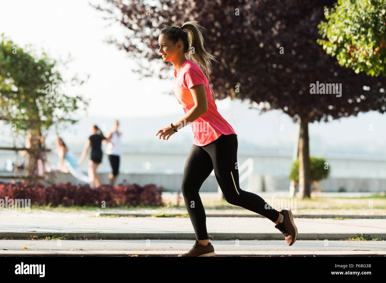 Young sporty girl jogging outdoor Stock Photo - Alamy
