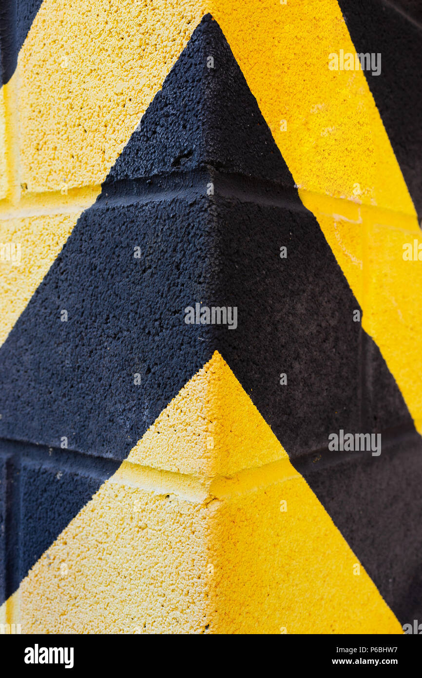 Yellow and black warning stripes on the corner of the building Stock ...