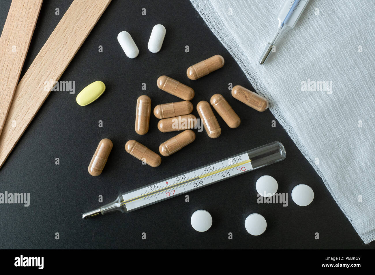 Traditional medical thermometer for measuring body temperature. Pills ...