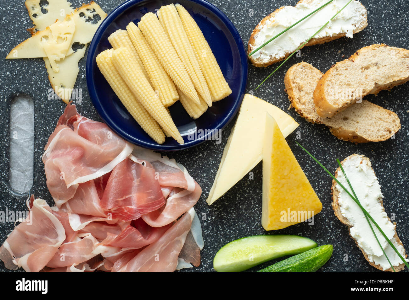 Cold appetizer. Cold cuts. Spicy food on black background, top view ...