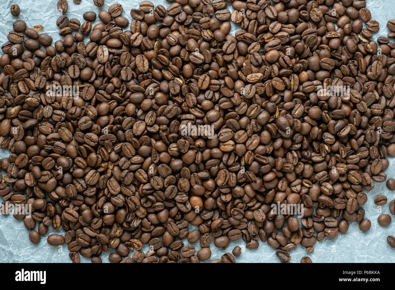 Coffee beans on crumpled paper Stock Photo - Alamy